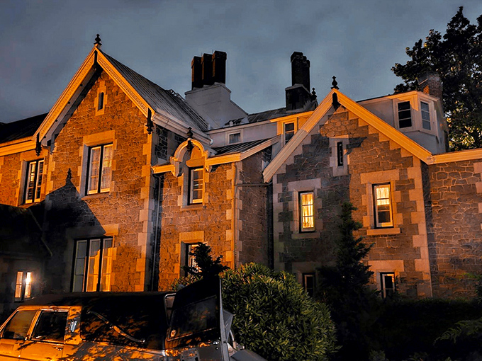 The mansion glows amber against the twilight sky, its stone fa&ccedil;ade and pointed gables silently whispering tales from another century. Like a Victorian ghost story come to life.
