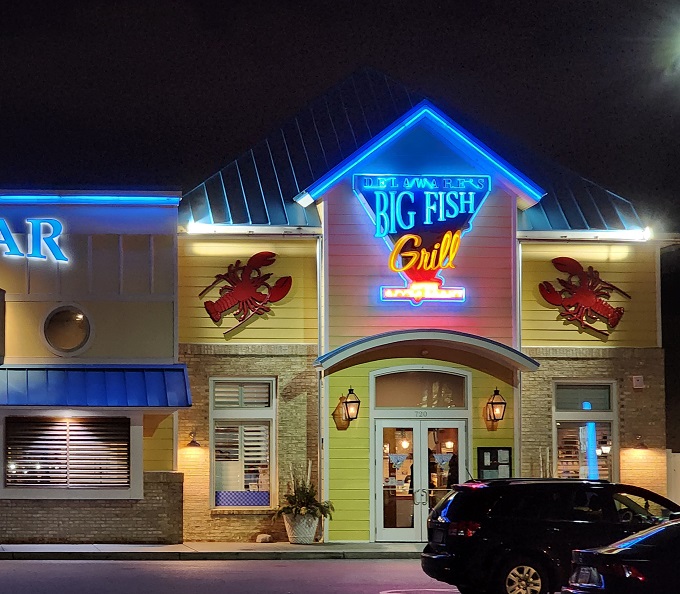 The cheerful yellow exterior of Big Fish Grill beckons like a maritime lighthouse for hungry souls. Blue accents and nautical touches promise seafood salvation ahead.