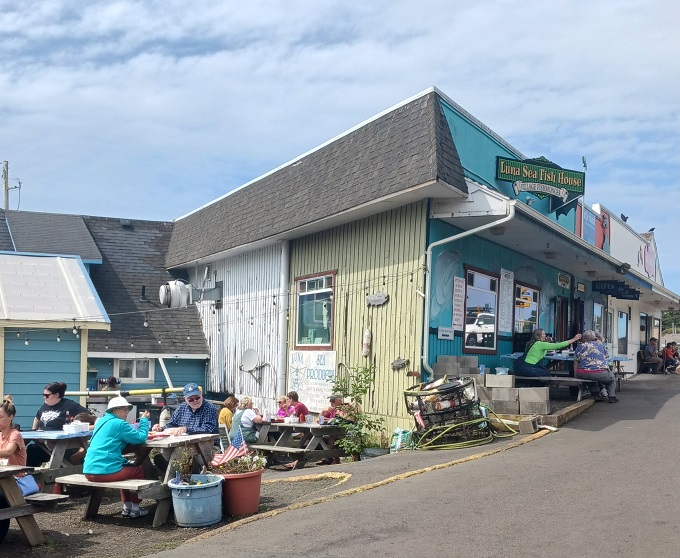 The turquoise beacon of Luna Sea Fish House stands out against Oregon's moody skies, promising seafood salvation to hungry coastal travelers.