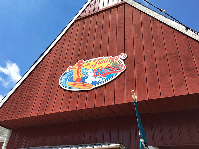 The iconic red barn exterior of Twilley's Willys stands like a beacon of hot dog hope against the Delaware sky, promising delicious adventures within.