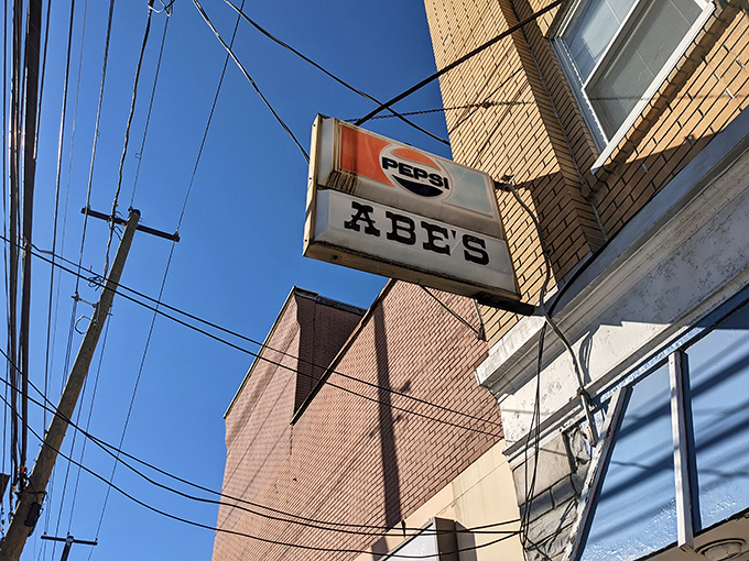 The classic American storefront that time forgot&mdash;complete with vintage sign, American flag, and the promise of comfort food that delivers on nostalgia. 