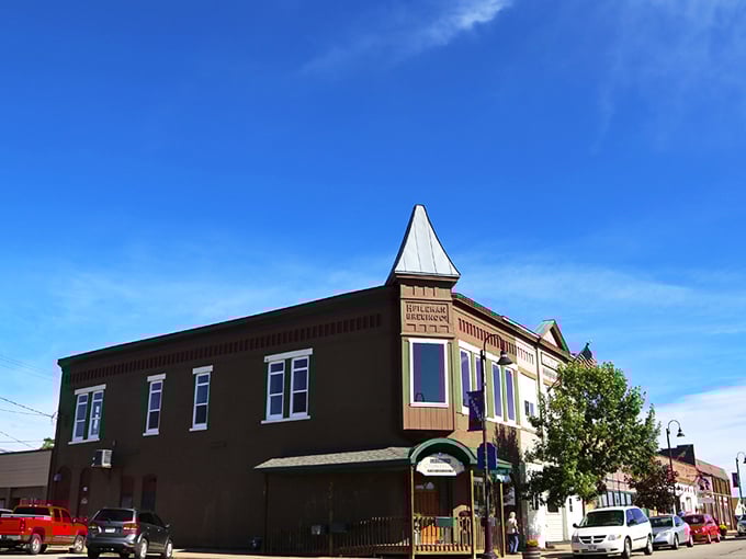 Colorful tiny shops at Down A Country Road create a garden oasis where Amish crafts find their showcase amid blooming flowers and comfortable seating areas.