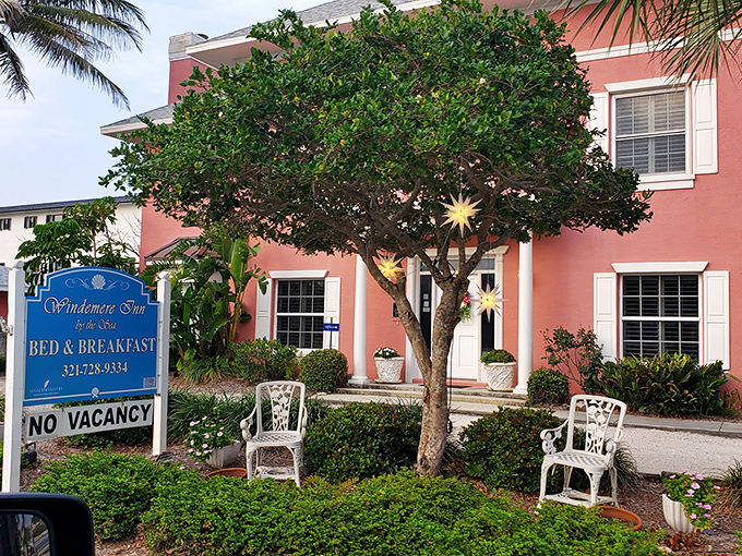 The coral-pink fa&ccedil;ade of Windermere Inn by the Sea stands like a blushing debutante against Florida's blue sky, promising coastal comfort with every white-trimmed window.