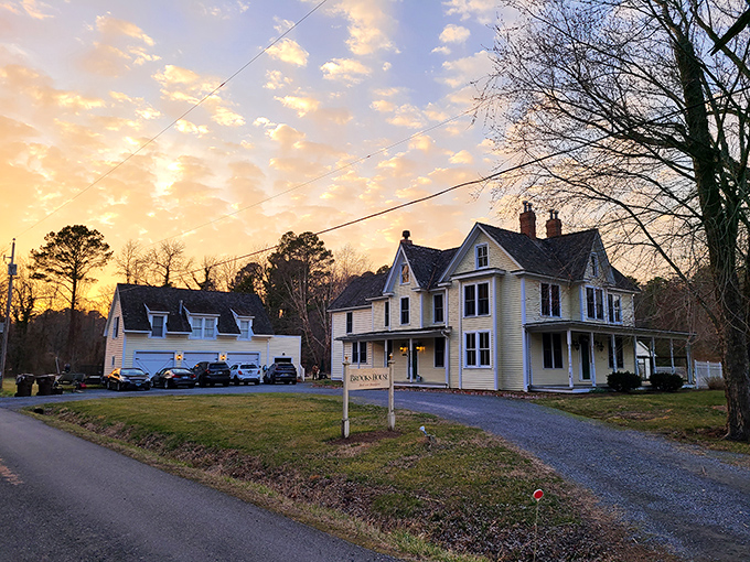 Sunset transforms this Victorian beauty into a watercolor painting come to life. The golden hour glow on that butter-yellow clapboard is nature's perfect filter.