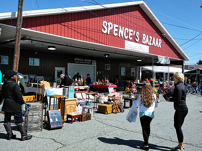 The iconic red facade of Spence's Bazaar stands like a beacon for bargain hunters, promising treasures waiting to be discovered inside and out.