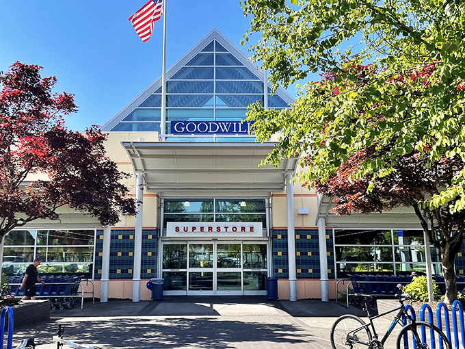 The iconic triangular entrance to Goodwill's Portland superstore stands like a beacon for treasure hunters, promising adventures in secondhand shopping beneath those blue letters. 