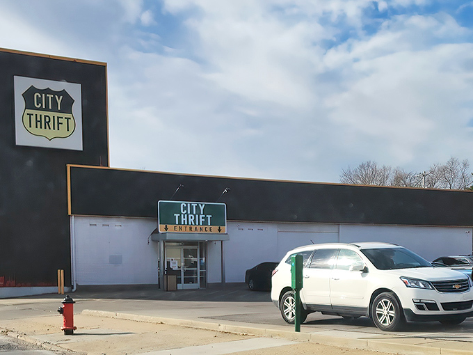 The iconic black and white exterior of City Thrift Waldo stands like a beacon for bargain hunters, complete with festive pennant flags that seem to whisper, "Treasures await inside!"