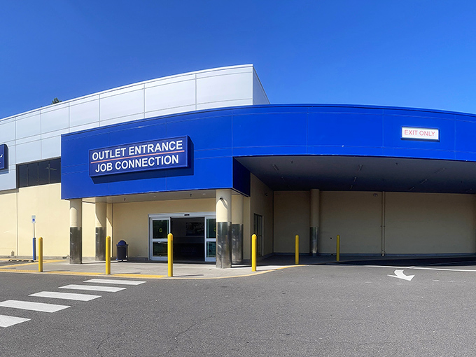 The blue and white facade of Goodwill's Outlet Entrance isn't just a storefront—it's the gateway to Portland's most ambitious treasure hunts.