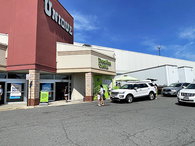 The iconic red facade of Unique Thrift Store stands like a beacon of bargain possibilities in Falls Church, promising treasures within those sliding glass doors.