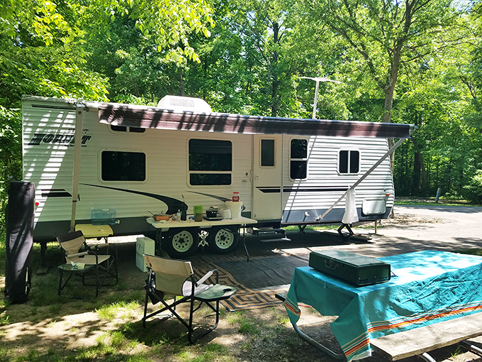 Home sweet temporary home! This spacious campsite offers the perfect blend of wilderness and comfort, complete with a turquoise picnic setup that screams "vacation mode activated."