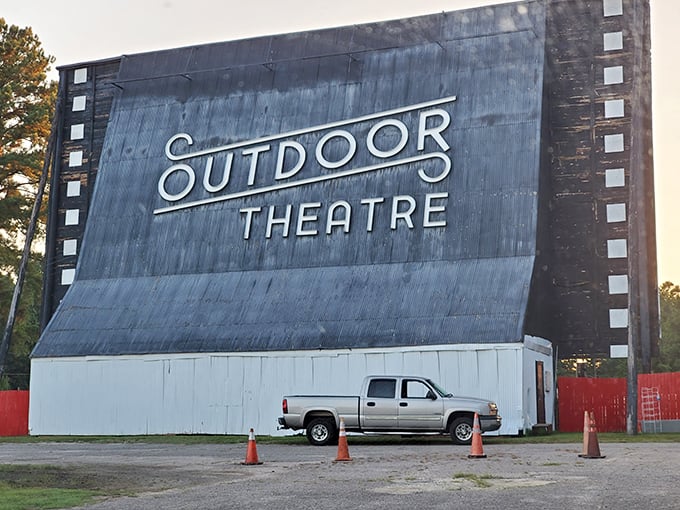 The iconic screen stands tall against the twilight sky, a weathered sentinel guarding decades of cinematic memories.