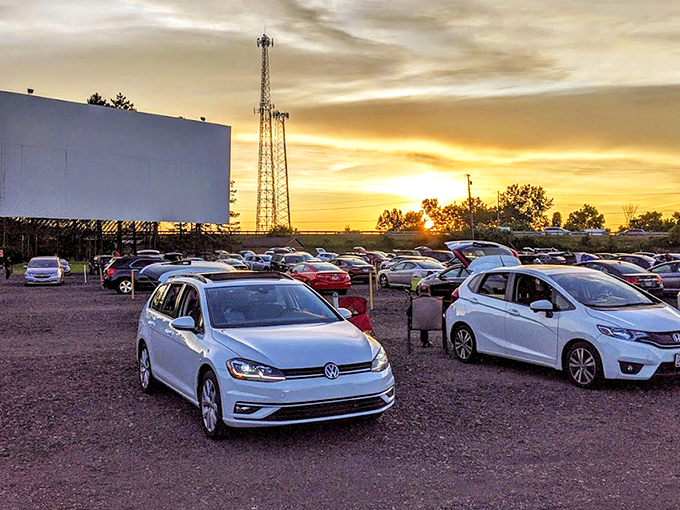 Twilight magic unfolds as cars gather beneath the massive screen, nature providing the perfect backdrop for cinema under an Ohio sunset.