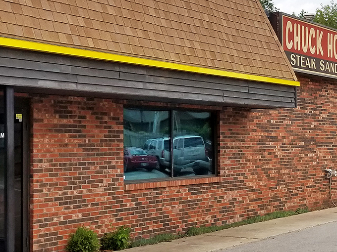 The unassuming brick exterior of Chuck House might not scream "culinary destination," but that yellow-trimmed roof has sheltered decades of delicious memories.