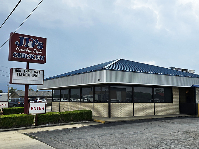 The iconic red and blue sign of J.D.'s Country Style Chicken stands as a beacon for hungry travelers along the highway in Hays, Kansas.