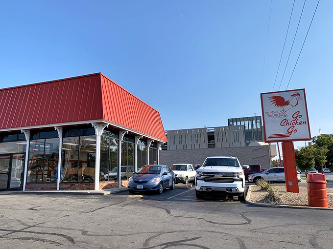 The iconic red-roofed building with its distinctive running chicken sign stands as a beacon of fried chicken perfection in Kansas City. 