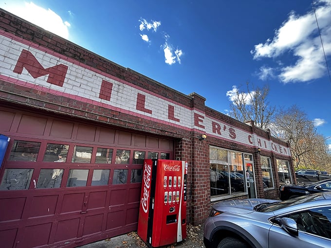The unassuming exterior of Miller's Chicken stands as a time capsule of Americana, complete with vintage Coca-Cola machine standing guard like a red sentinel.