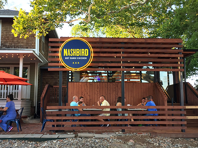 NASHBIRD's charming converted house exterior beckons with its wooden deck and bright signage&mdash;like a Southern porch that happens to serve life-changing chicken.