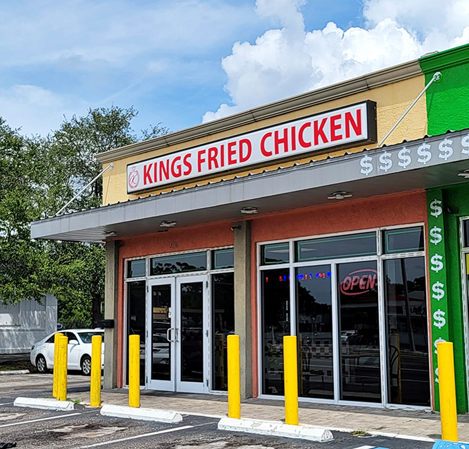 The bright yellow facade with bold red lettering stands as a no-nonsense declaration: this place means serious business when it comes to fried chicken.