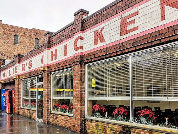 The unassuming exterior of Miller's Chicken stands as a time capsule of Americana, complete with vintage Coca-Cola machine standing guard like a red sentinel.