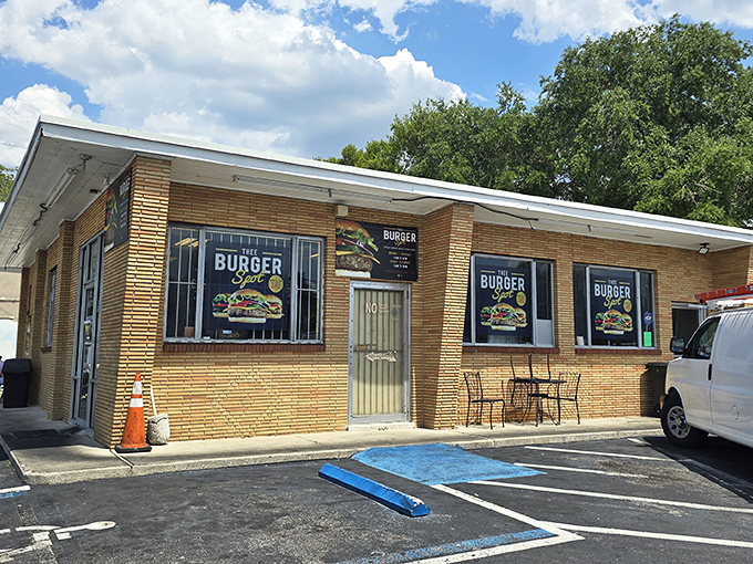 Unassuming brick exterior, colorful burger signage - Thee Burger Spot makes no architectural promises, just a humble brick declaration that burger greatness awaits within.