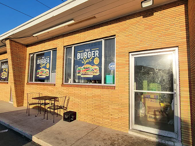 Unassuming brick exterior, colorful burger signage - Thee Burger Spot makes no architectural promises, just a humble brick declaration that burger greatness awaits within.