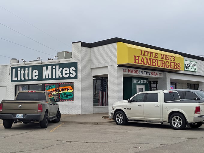 The bright yellow sign beckons like a burger lighthouse on the Oklahoma horizon. Nothing says "American classic" quite like that patriotic banner.