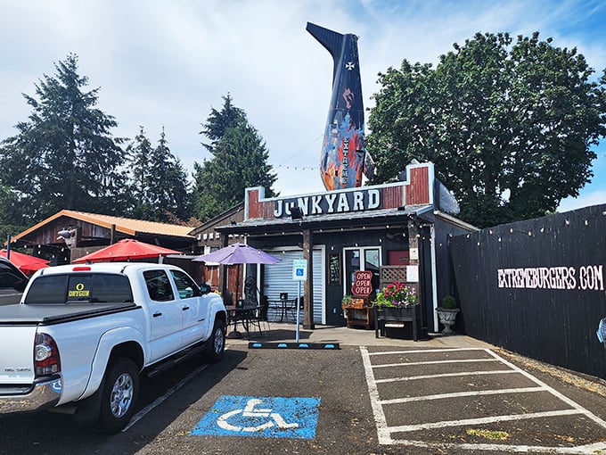 Not your average roadside stop! Junkyard's distinctive fin-shaped sign beckons hungry travelers like a burger lighthouse guiding ships to delicious shores.
