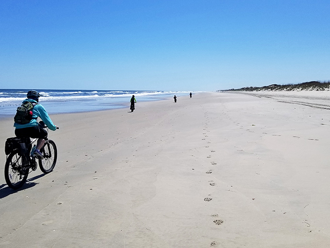 A bright yellow tent stands alone on miles of pristine shoreline. Social distancing at its most glorious natural extreme.