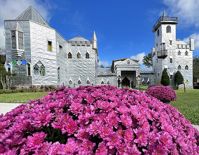 The shimmering facade of Solomon's Castle catches Florida sunlight like a medieval disco ball, complete with vibrant pink flowers that seem to bow in admiration.