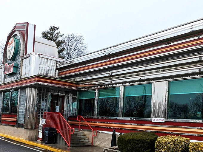The neon-lit facade of Double T Diner glows like a beacon for hungry travelers. Classic glass blocks and chrome trim scream "authentic American diner experience."