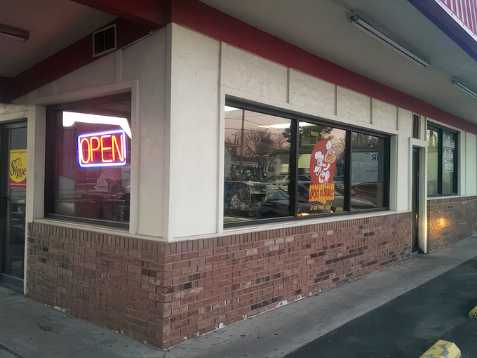 The iconic red-roofed Dog N Suds stands like a time capsule against the Arkansas sky, beckoning hungry travelers with promises of nostalgic delights.