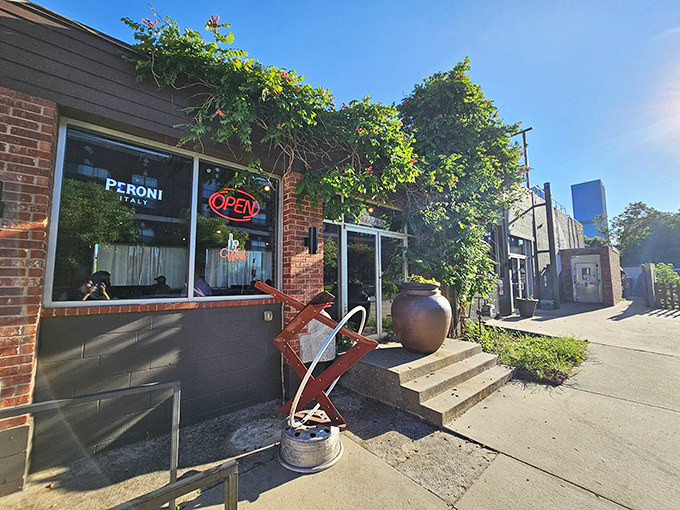 The Wedge's exterior is like a colorful storybook come to life. That vibrant orange fence and playful mural practically scream "good times and great pizza await inside!"