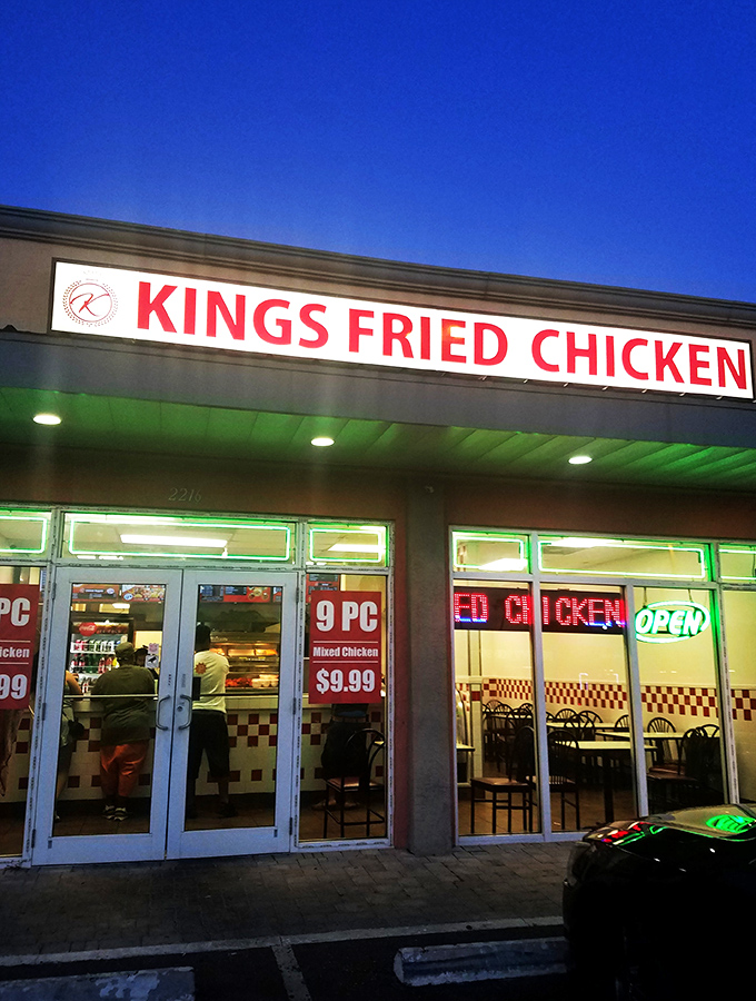 The bright yellow facade with bold red lettering stands as a no-nonsense declaration: this place means serious business when it comes to fried chicken.