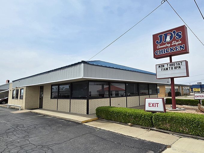 The unassuming blue-roofed building with its simple red sign might not scream "culinary destination," but locals know better. This modest exterior houses Kansas fried chicken royalty.