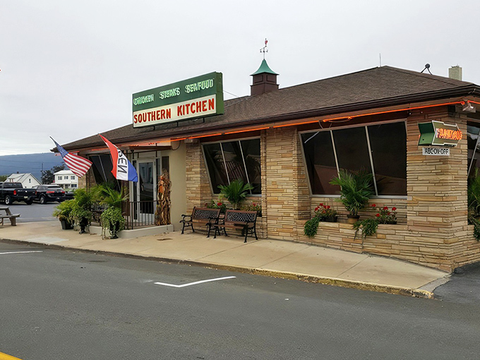 The stone facade of Southern Kitchen stands proudly in New Market, where that green sign has been beckoning hungry travelers for generations. American flags flutter in the mountain breeze, promising patriotic portions inside.