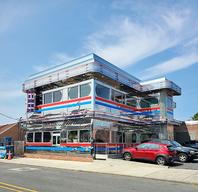 The gleaming chrome exterior of Goobers Diner stands like a time machine to the 1950s, complete with those iconic red and blue stripes that practically scream "great breakfast inside!"
