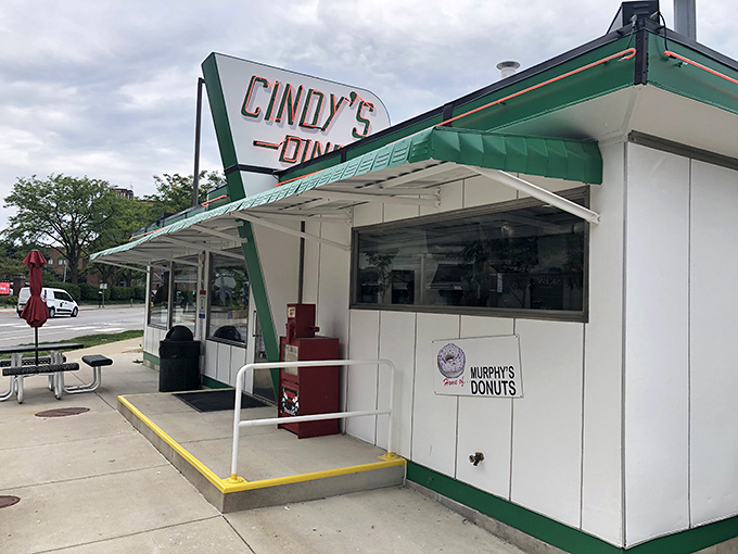 The classic green and white exterior of Cindy's Diner stands proudly in downtown Fort Wayne, promising breakfast magic with its vintage charm.