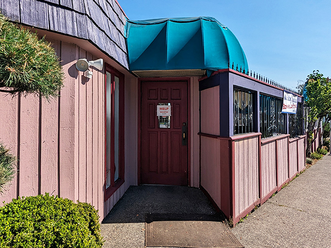 The welcoming teal awning and pink exterior of Cameo Cafe East beckons like a colorful promise of breakfast bliss in Portland's morning landscape. 