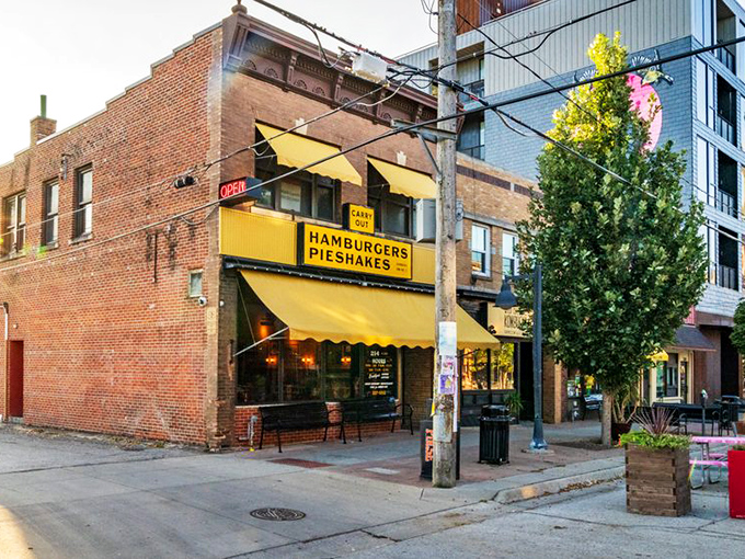 That iconic yellow awning boldly proclaiming "HAMBURGERS PIESHAKES" is like a beacon of comfort food hope on an Iowa City street corner.