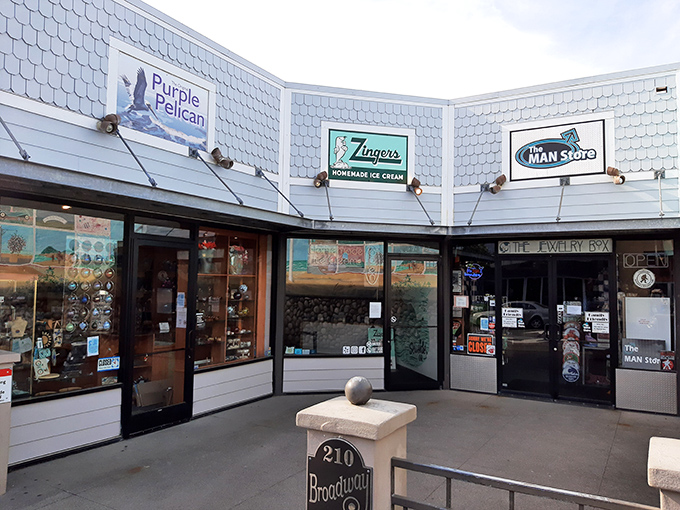 The iconic blue-shingled exterior of Zingers stands like a beacon of sweet promises on Seaside's Broadway Street, complete with their playful sea lion mascot. 