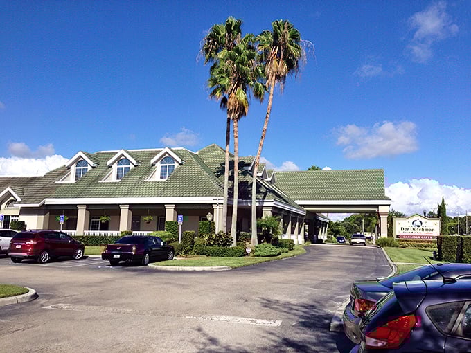 Where Amish tradition meets Florida sunshine. The green-roofed farmhouse style of Der Dutchman creates an unexpected oasis amid swaying palm trees.