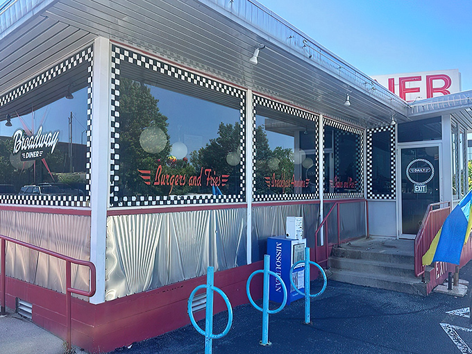 The classic checkerboard trim instantly telegraphs "authentic diner experience ahead" &ndash; a roadside beacon promising comfort food and conversation in equal measure.