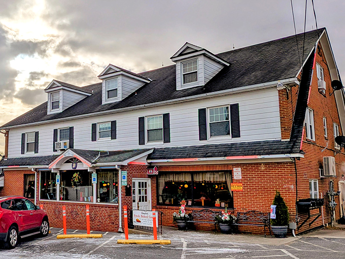 The classic white colonial exterior of Baugher's stands like a beacon of comfort food promise against Maryland's blue skies.