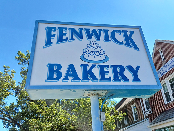 The iconic blue and white sign stands like a beacon of sweetness against the Baltimore sky, promising delicious traditions since 1913.