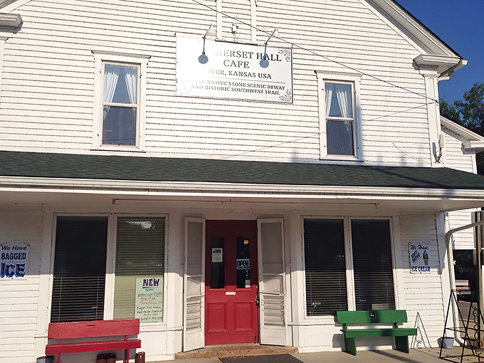 The white clapboard exterior with its cherry-red door isn't trying to impress anyone, which is exactly why it's so impressive. Small-town Kansas perfection.