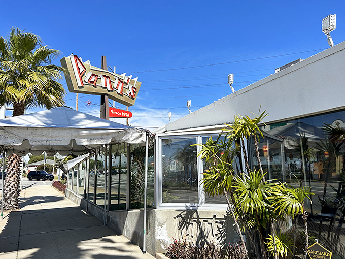 That iconic angular roof isn't just showing off&mdash;it's practically waving you in from the highway, promising comfort food beneath its Googie glory.