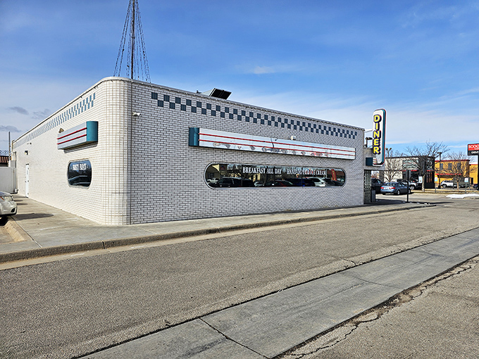 That classic white brick exterior with the checkerboard trim isn't just architecture—it's a promise of comfort food paradise waiting inside.