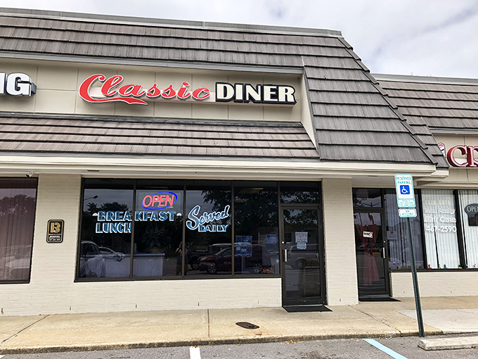 The shingled exterior of Classic Diner beckons with its bold red script and neon promise of daily breakfast. Some buildings just look like they know how to feed you right.