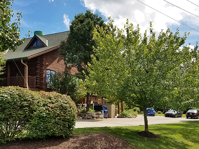 The grand timber entrance beckons with rustic elegance, promising cozy comforts behind those striking teal doors &ndash; a woodland sanctuary minutes from city bustle. 