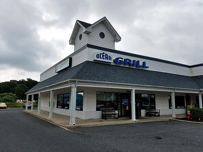 The white clapboard exterior of Ocean Grill stands like a beacon of comfort food promise. Those nautical round windows aren't just for show&mdash;they're portals to flavor town. 